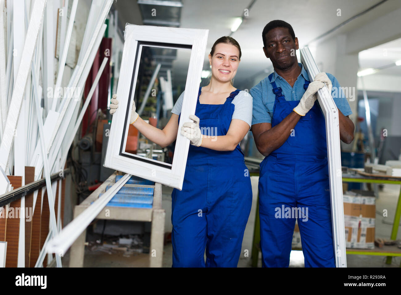 Two masters are working with window frame in the window workshop Stock ...