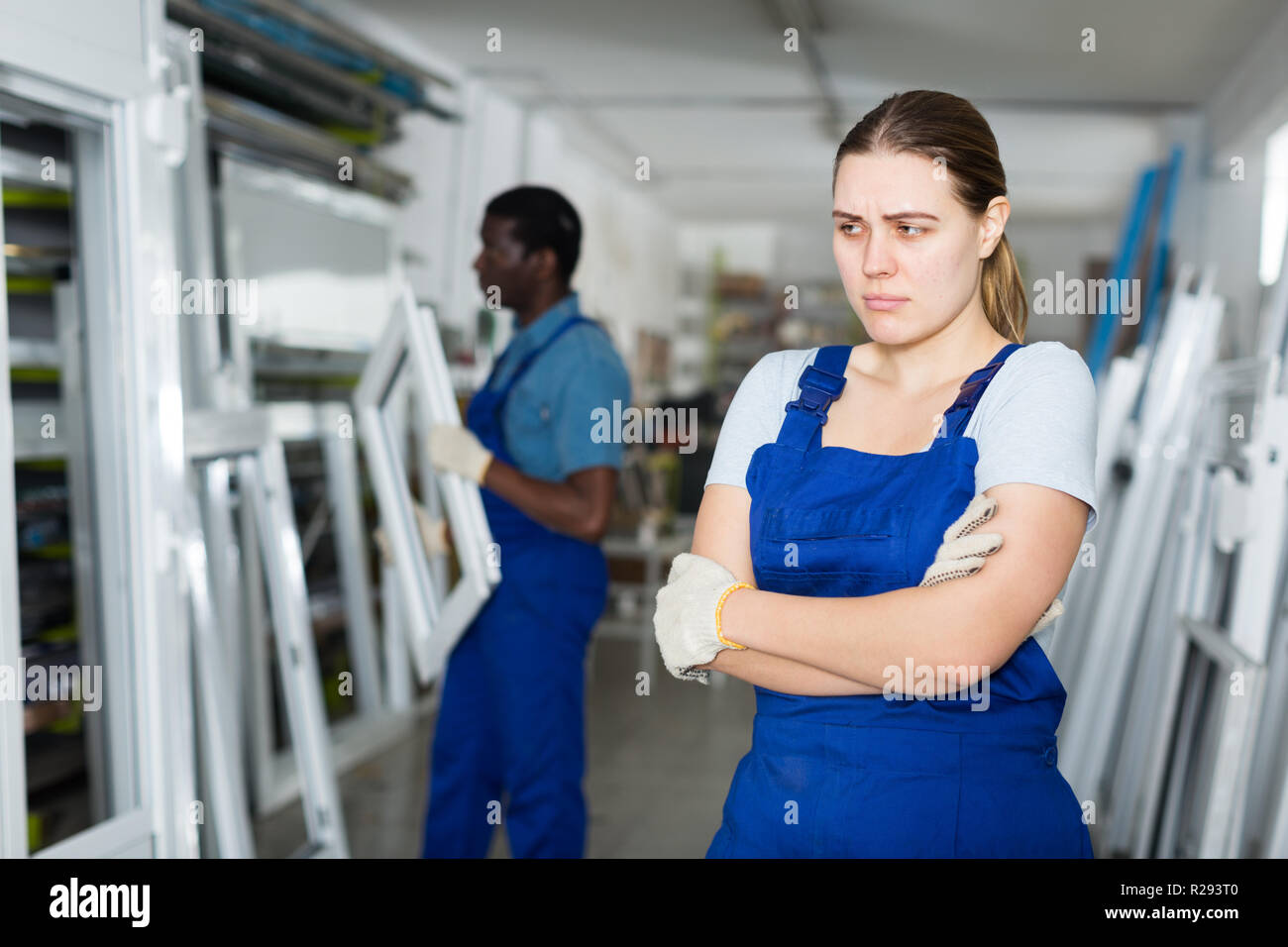 Portrait of female master who is upset in time working on her workplace ...