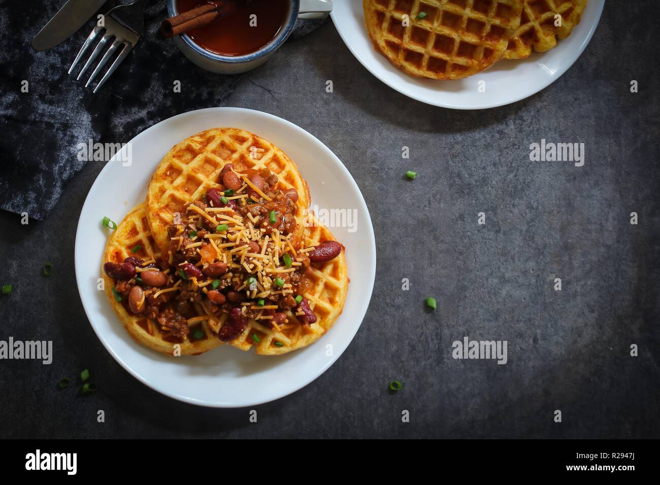 Cornbread cheddar wafflaes with Chili topping overhead view ...