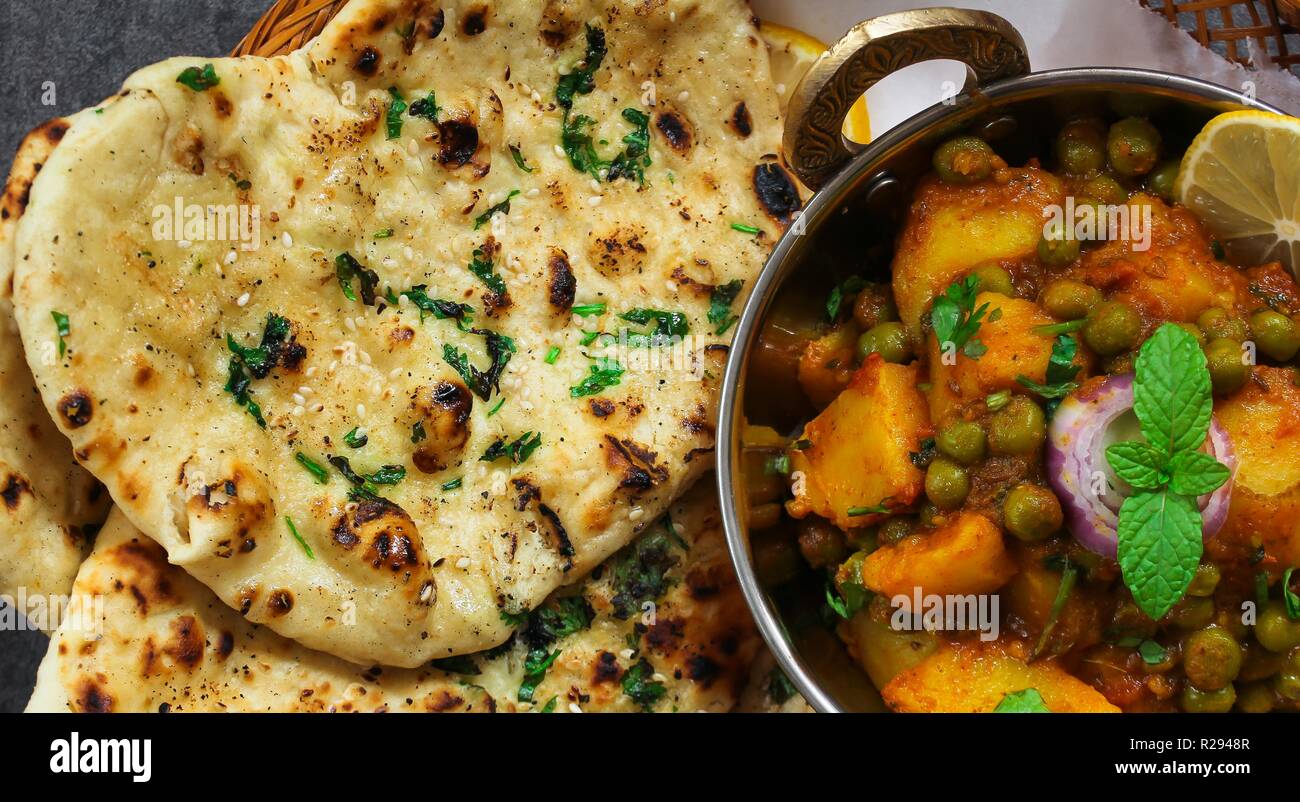 Homemade Kulcha / Indian flat bread Butter Naan served with Alu Matar ...