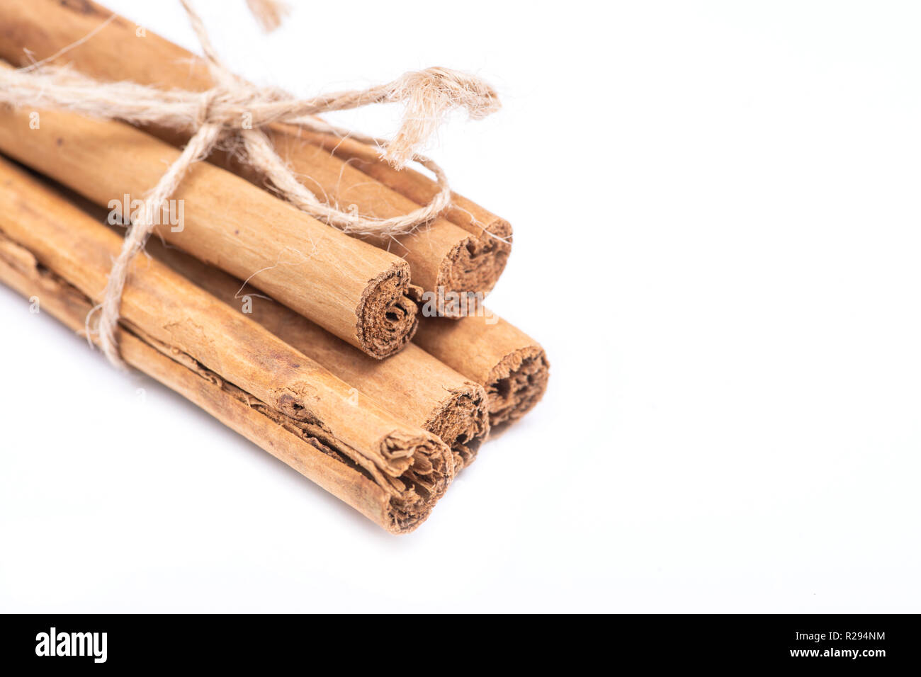 Cinnamon sticks tied with jute rope isolated on white background Stock ...