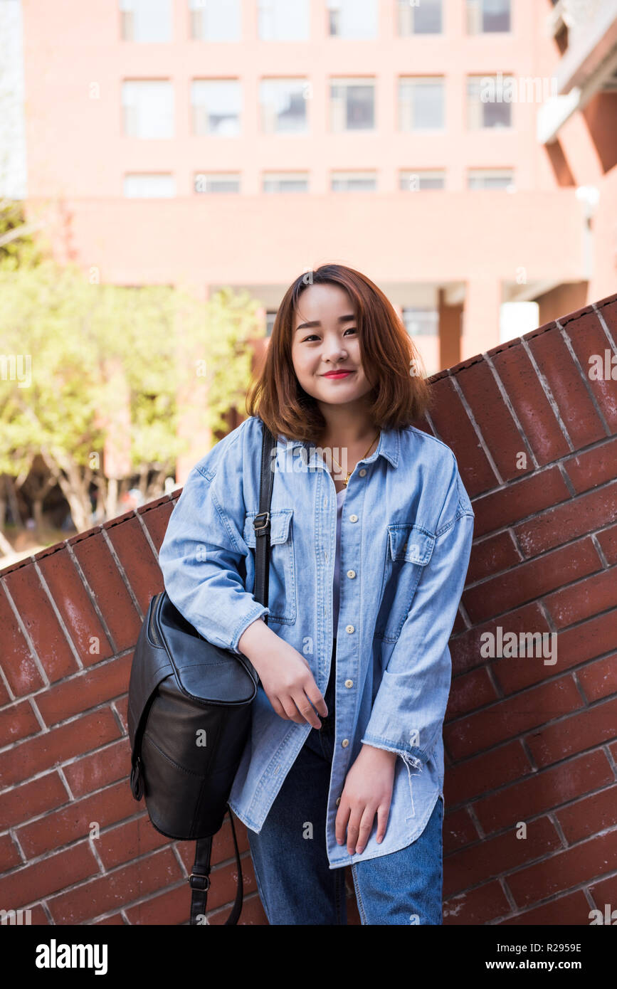 Girl student standing with backpack or school bag smiling happy ...