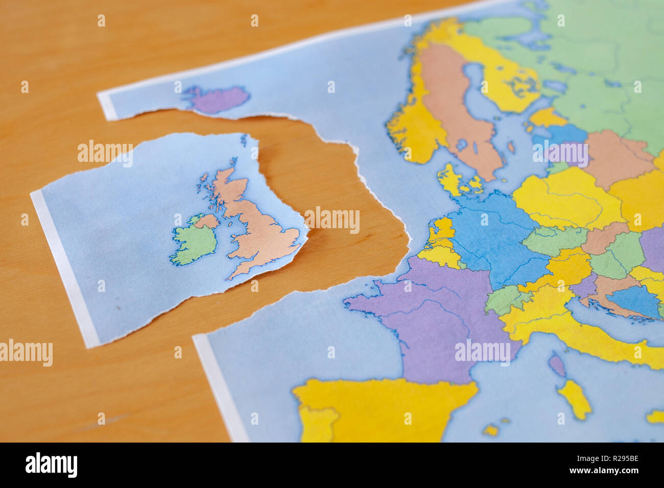 a torn paper map symbolizing the UK leaving the European Union or ...