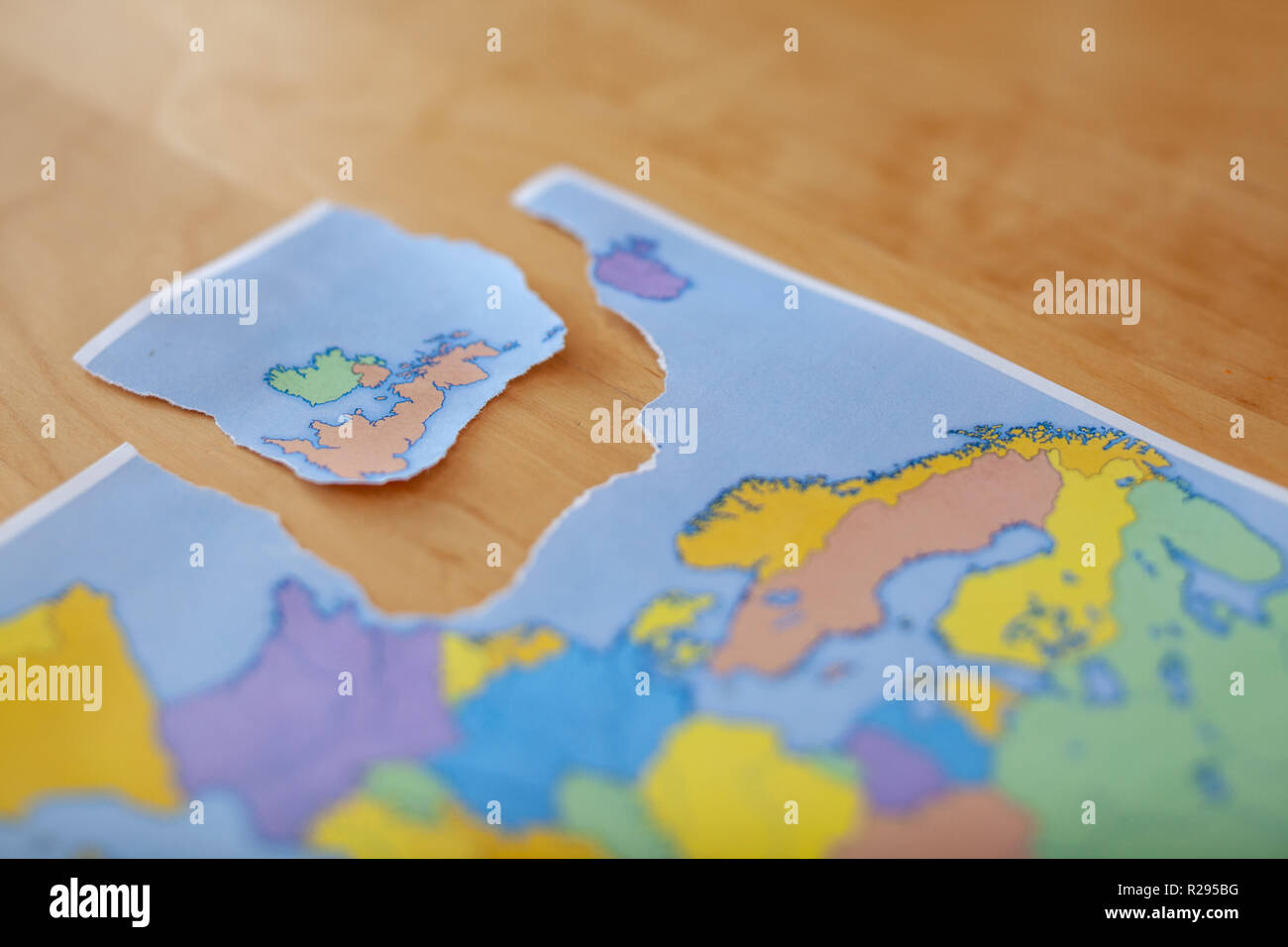 a torn paper map symbolizing the UK leaving the European Union or ...