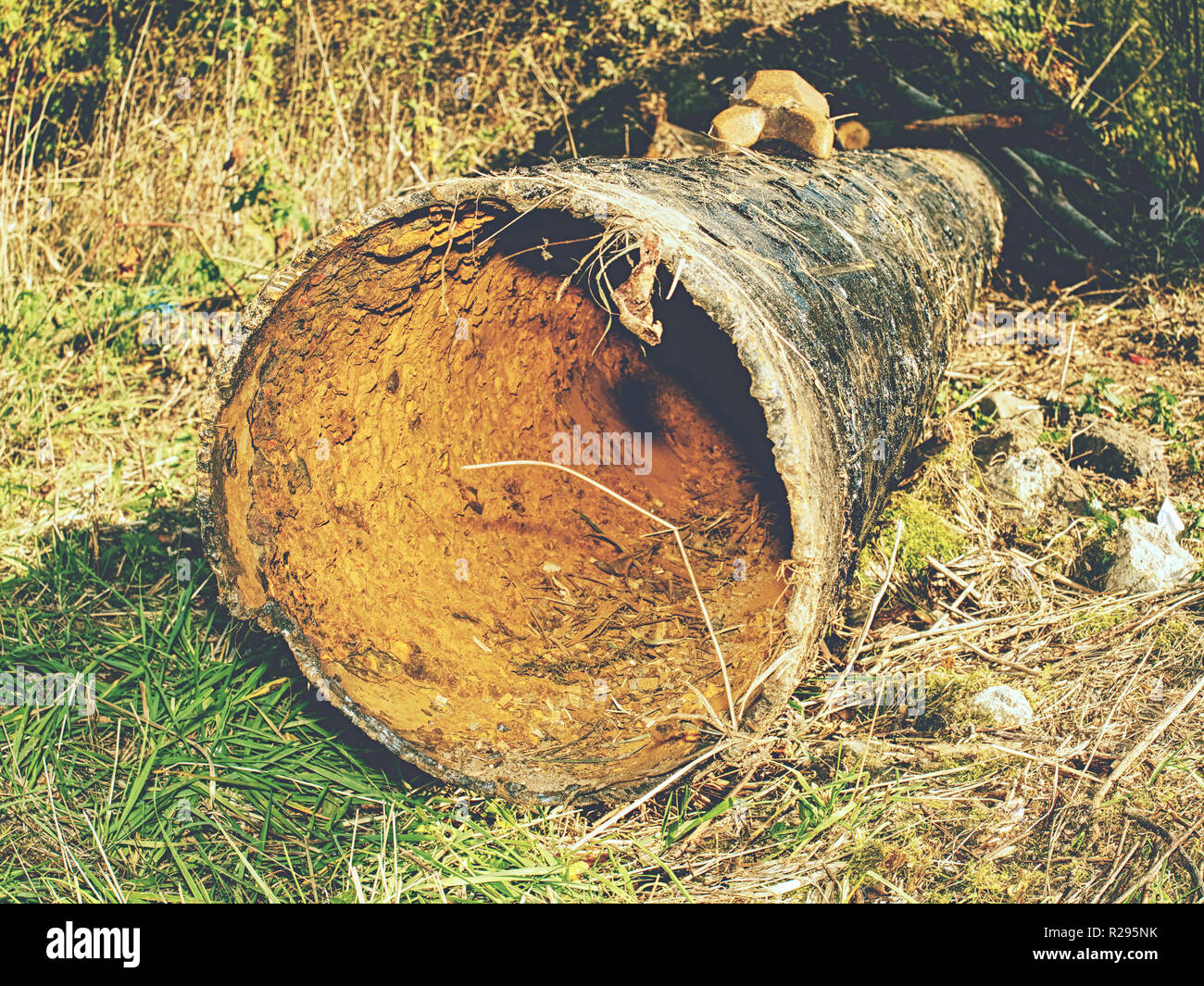 Long metal pipe laying on ground. Broken rusty steel tube. Open trench ...