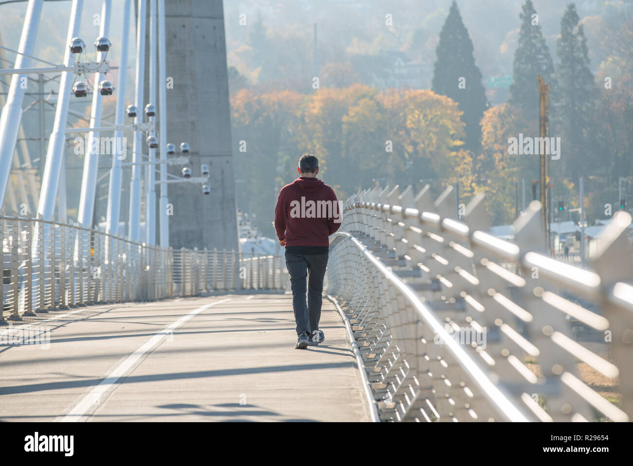 Man walking on metal bridge hi-res stock photography and images - Alamy