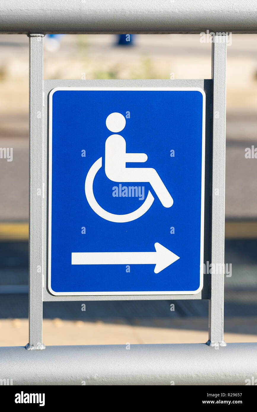 Blue handicap sign with an arrow Stock Photo - Alamy
