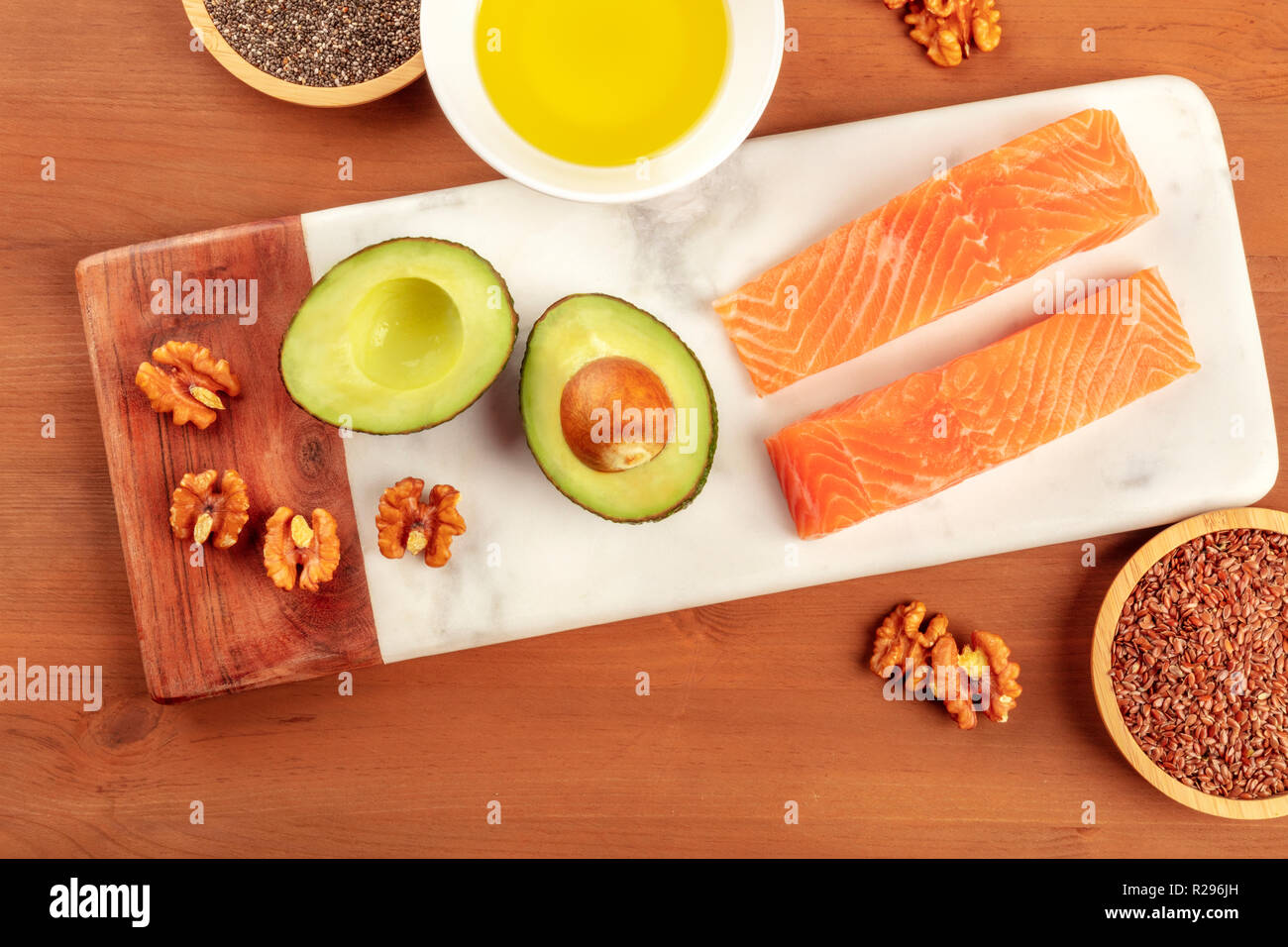 A photo of healthy omega 3 diet foods. Salmon, avocado, walnuts, chia ...