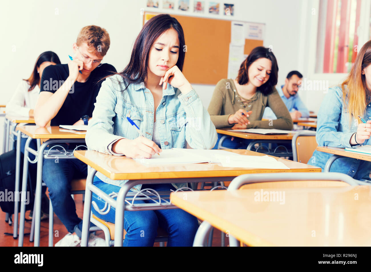 Young girl is learning and answering the question on paper in the class ...