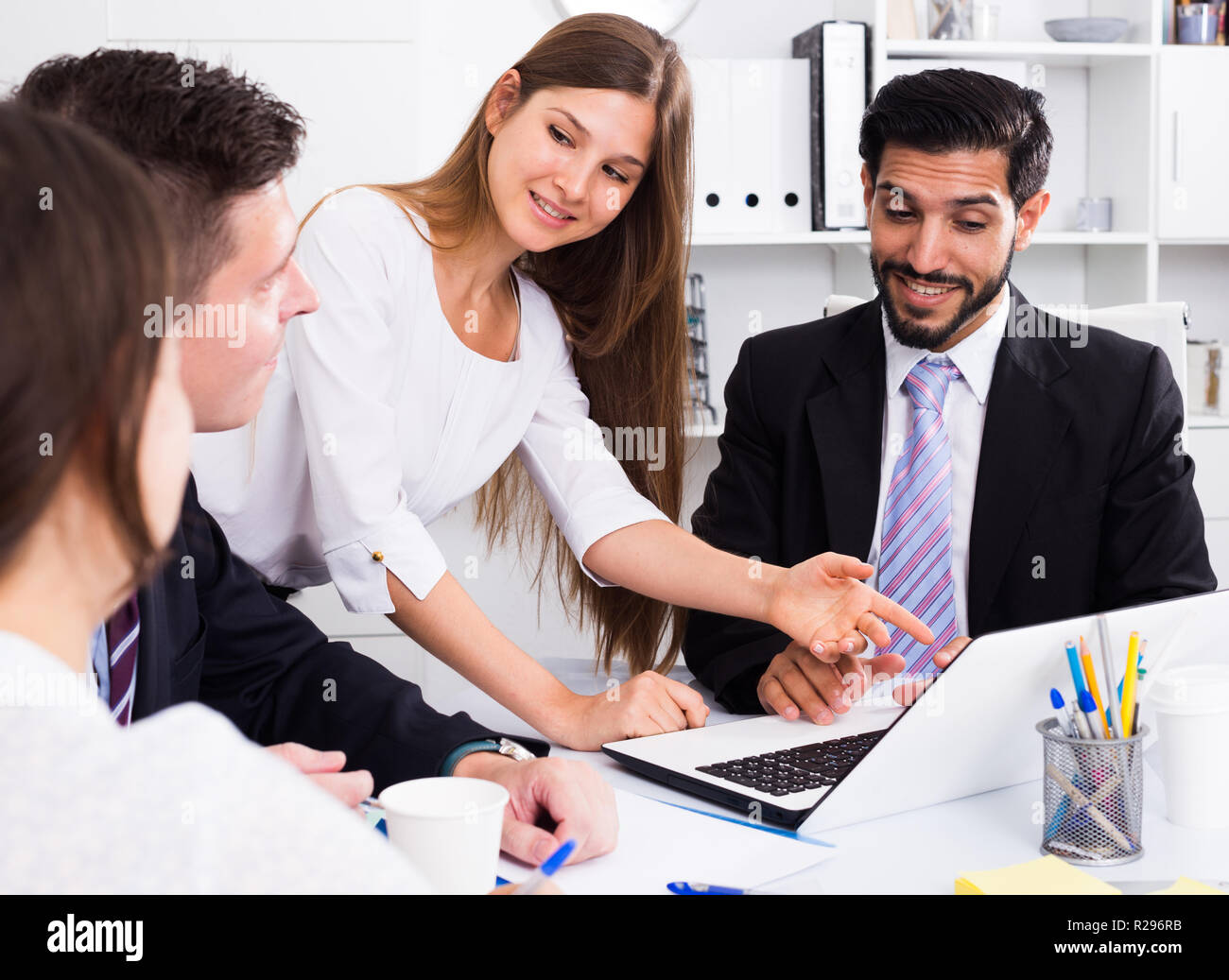 Group of confident business colleagues planning work at joint meeting ...