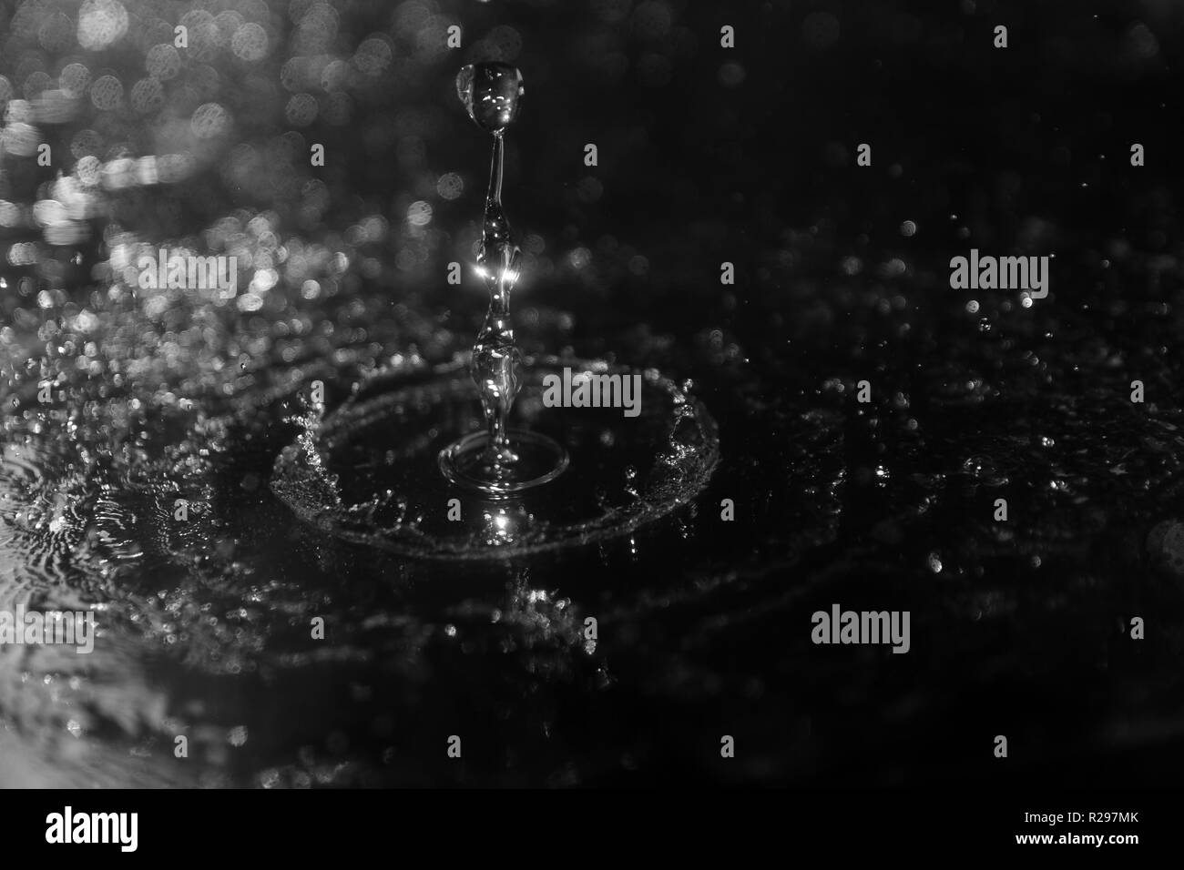 squirt, splash of water on a black background, drops Stock Photo - Alamy