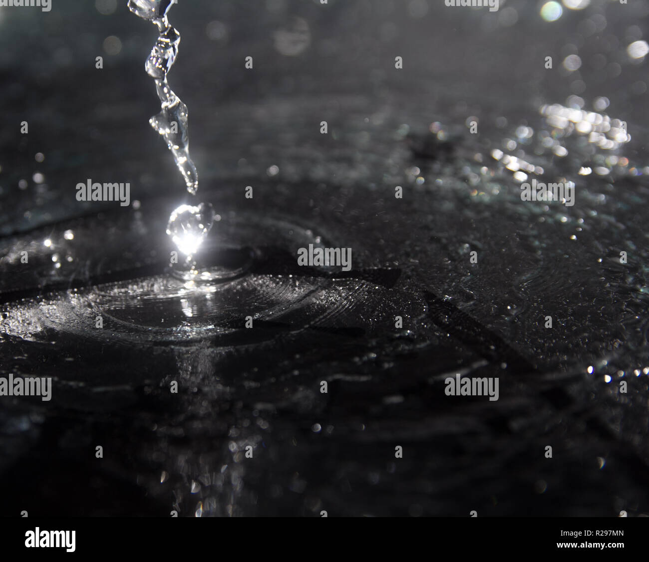 squirt, splash of water on a black background, drops Stock Photo - Alamy