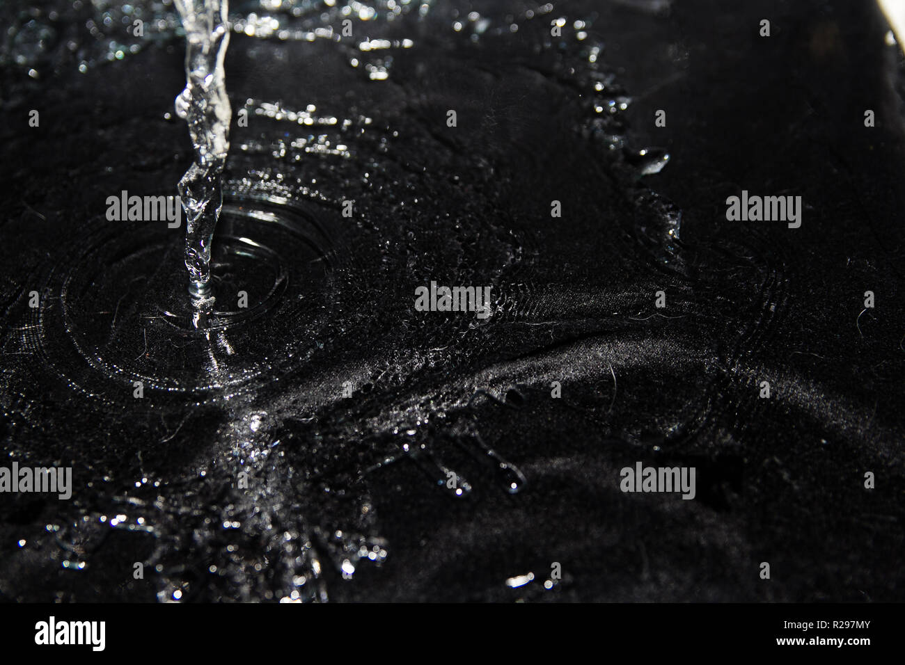 squirt, splash of water on a black background, drops Stock Photo - Alamy