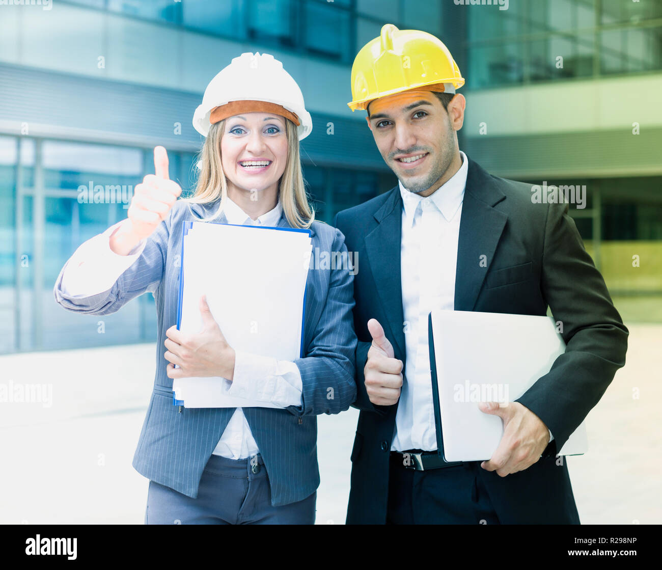 Smiling engineer and woman designer are pleased with realisation their ...