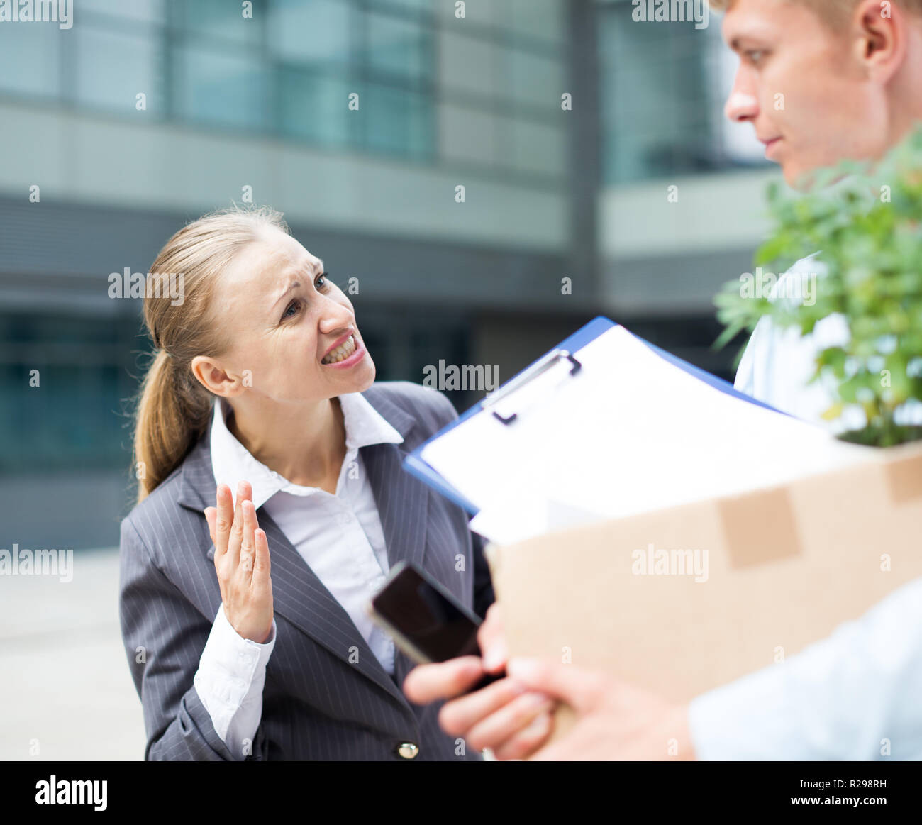 Angry businesswoman is chastising the employee for violating the job ...