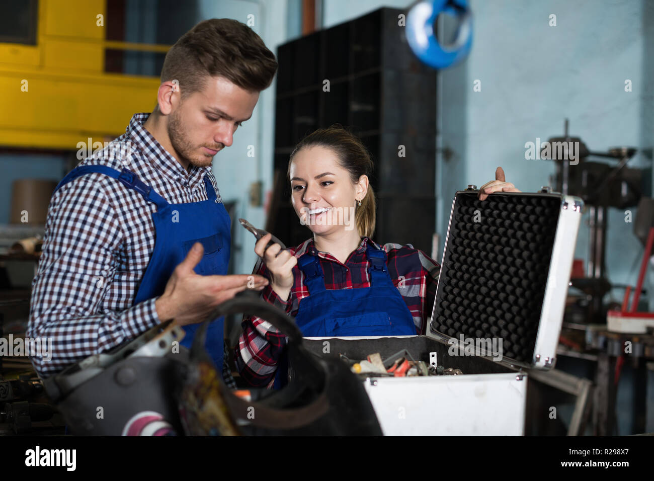 Two young masters are looking tools in box in workplace Stock Photo - Alamy