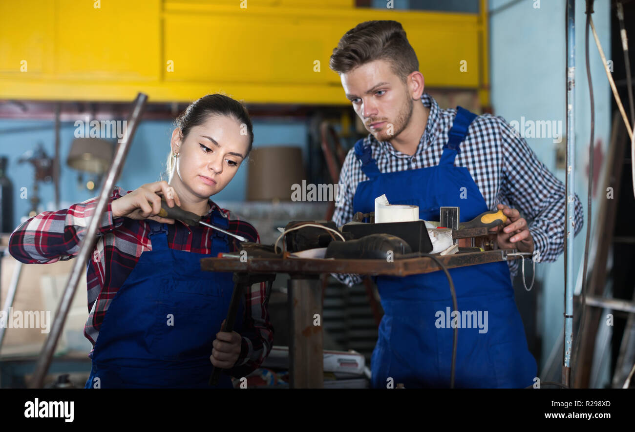 Two masters are working together in workshop Stock Photo - Alamy