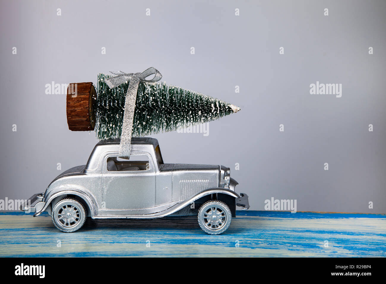 Silver retro car with a tree on the roof. Christmas decor. Car model ...
