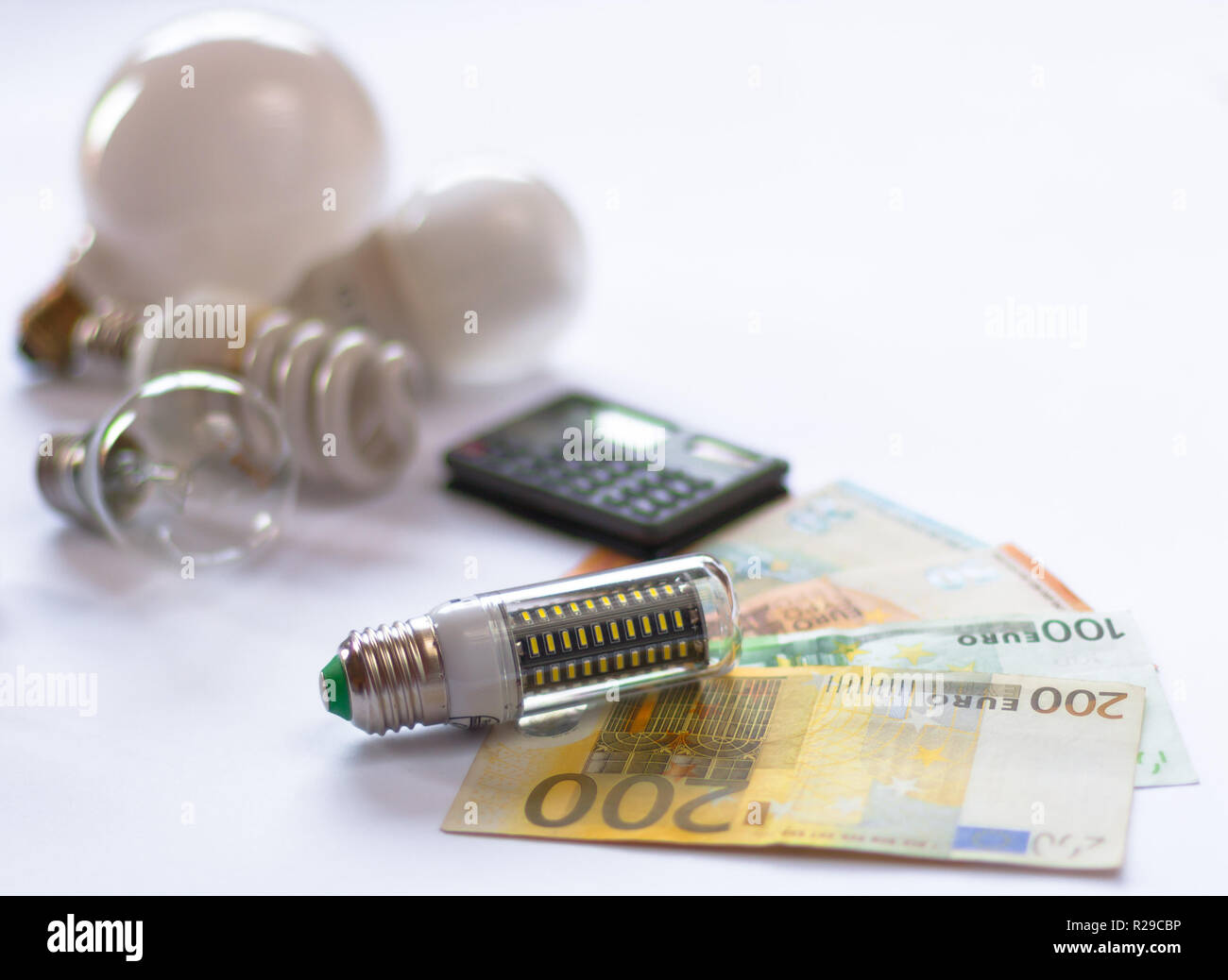 Led Light Bulb on european cash banknotes. Different kind of bulbs and ...