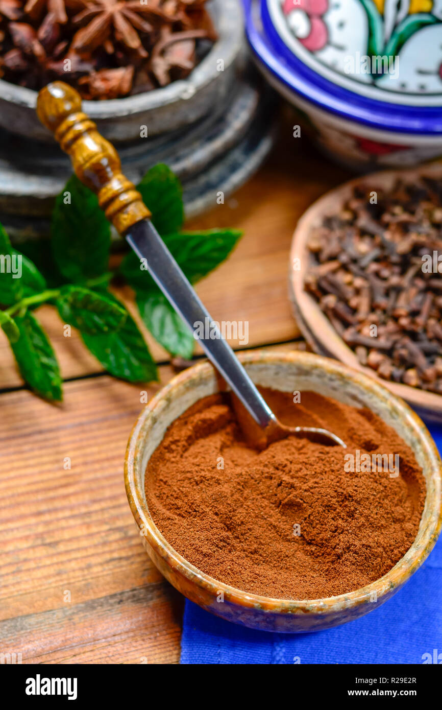 Bowls with dried clove buds and cloves powder, used for cooking and ...