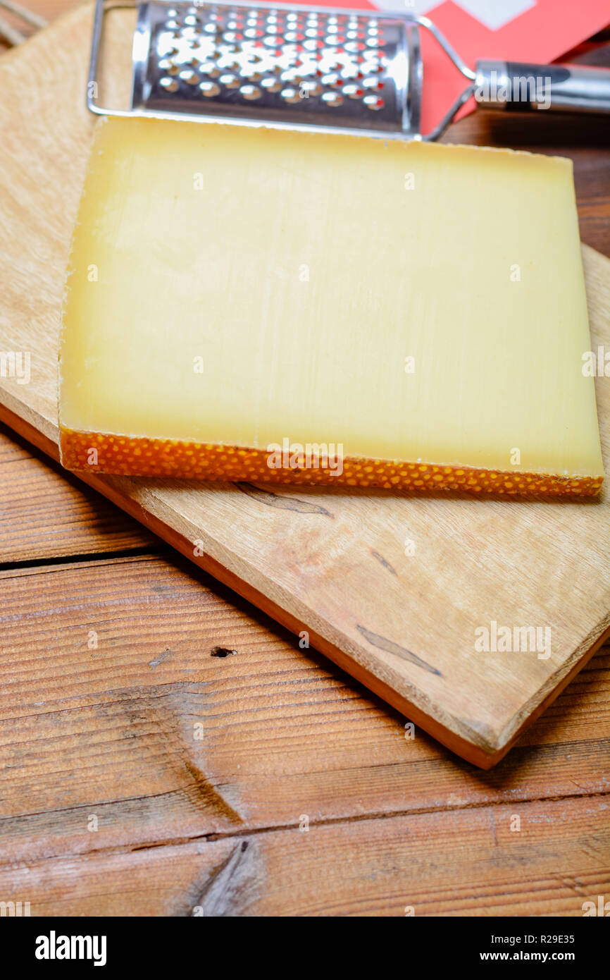 Block of Swiss hard cheese Le Gruyere used for traditional fondue and ...