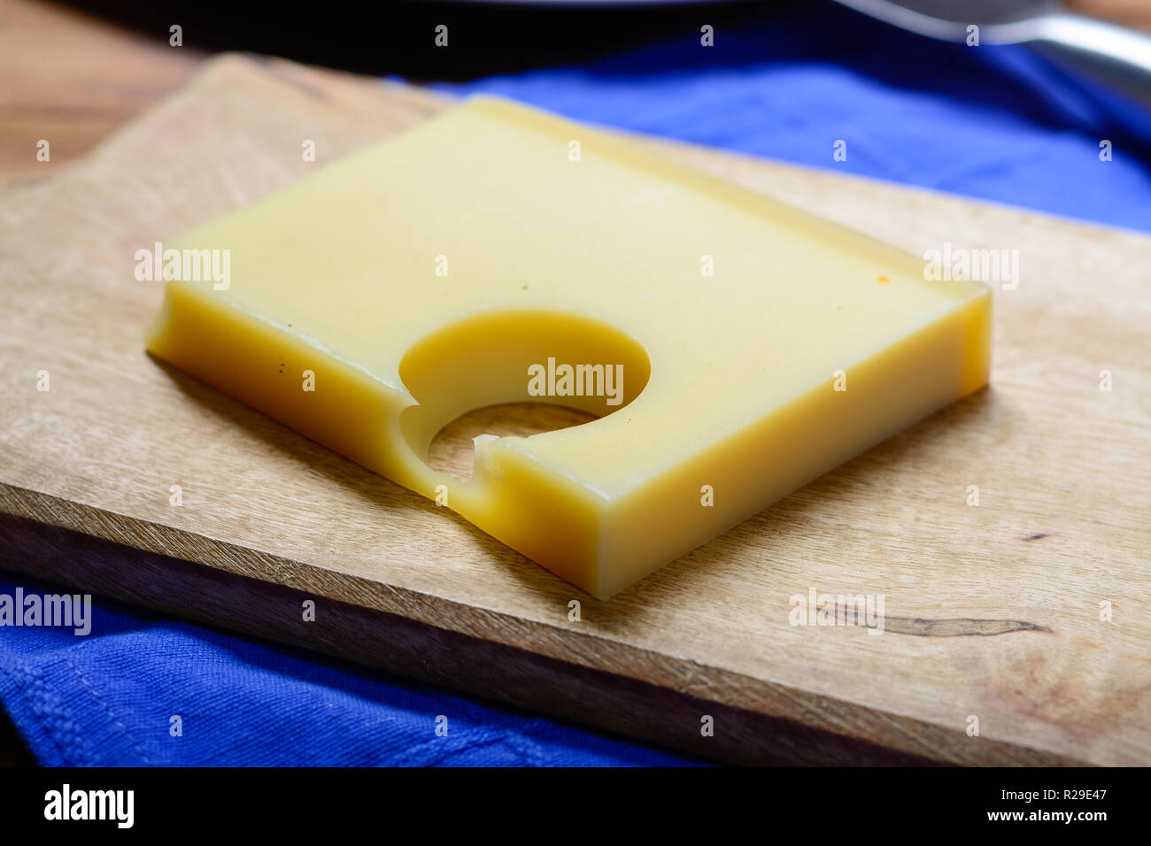 Block of Swiss Emmental or Emmentaler medium-hard cheese with round ...