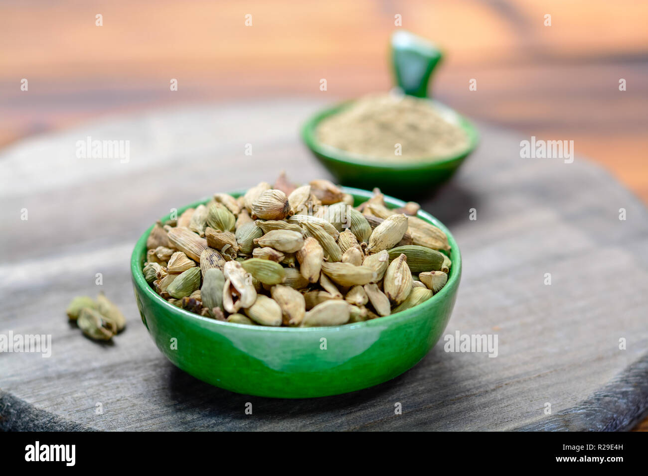 Bowl with cardamom pots and cardamom powder, used for cooking and ...