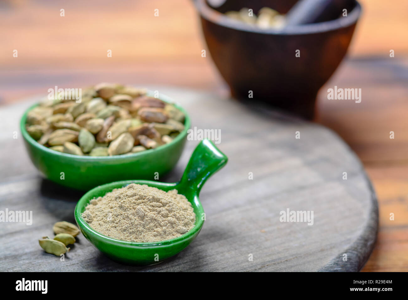 Bowl with cardamom pots and cardamom powder, used for cooking and ...