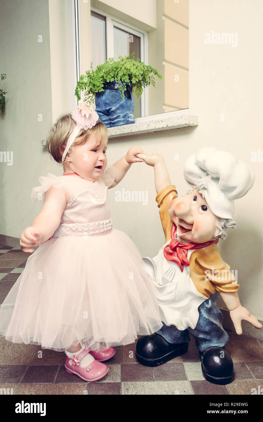 A little kid hugs a toy dwarf. 2018 Stock Photo - Alamy