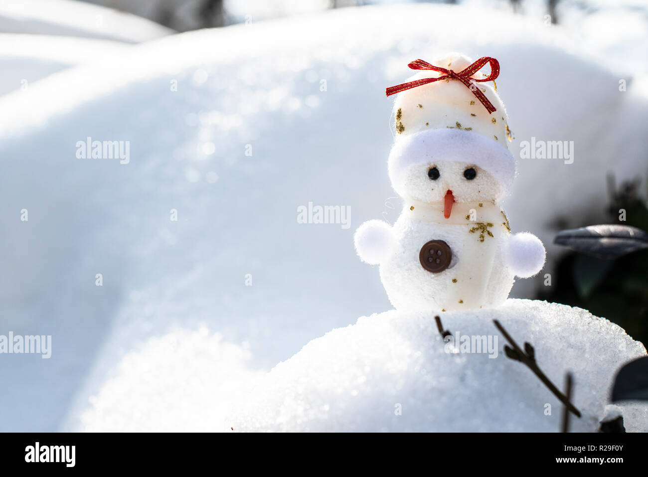 Little snowman on snow. Back sun light Stock Photo - Alamy