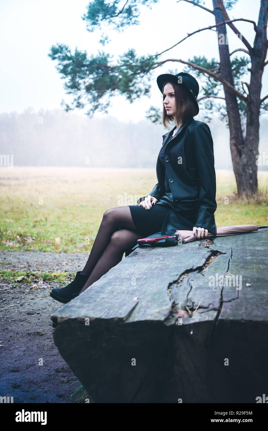 girl sitting on a bench Stock Photo - Alamy