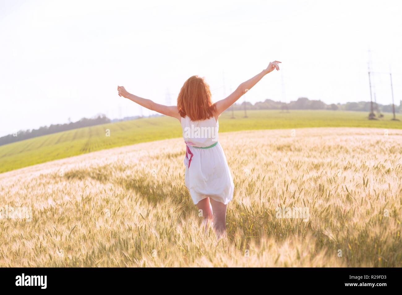 happy summer and freedom. Beautiful girl run at the wheat field on a ...