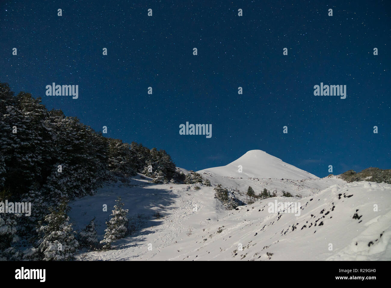 Landscape of a snowy volcano at night, with very starry sky Stock Photo ...