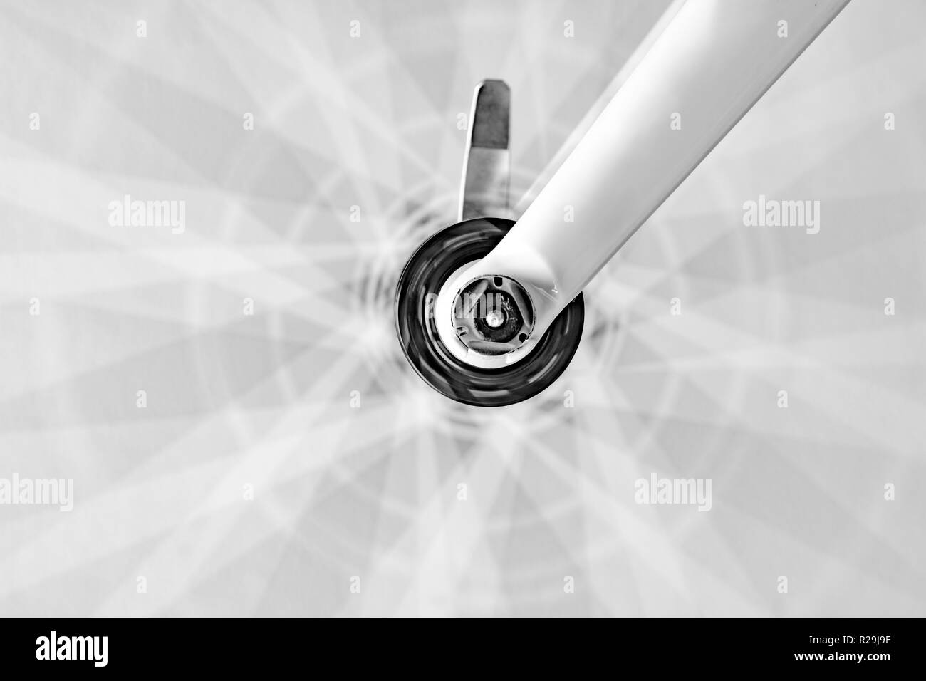 The front wheel of the bicycle rotates quickly on a white background ...