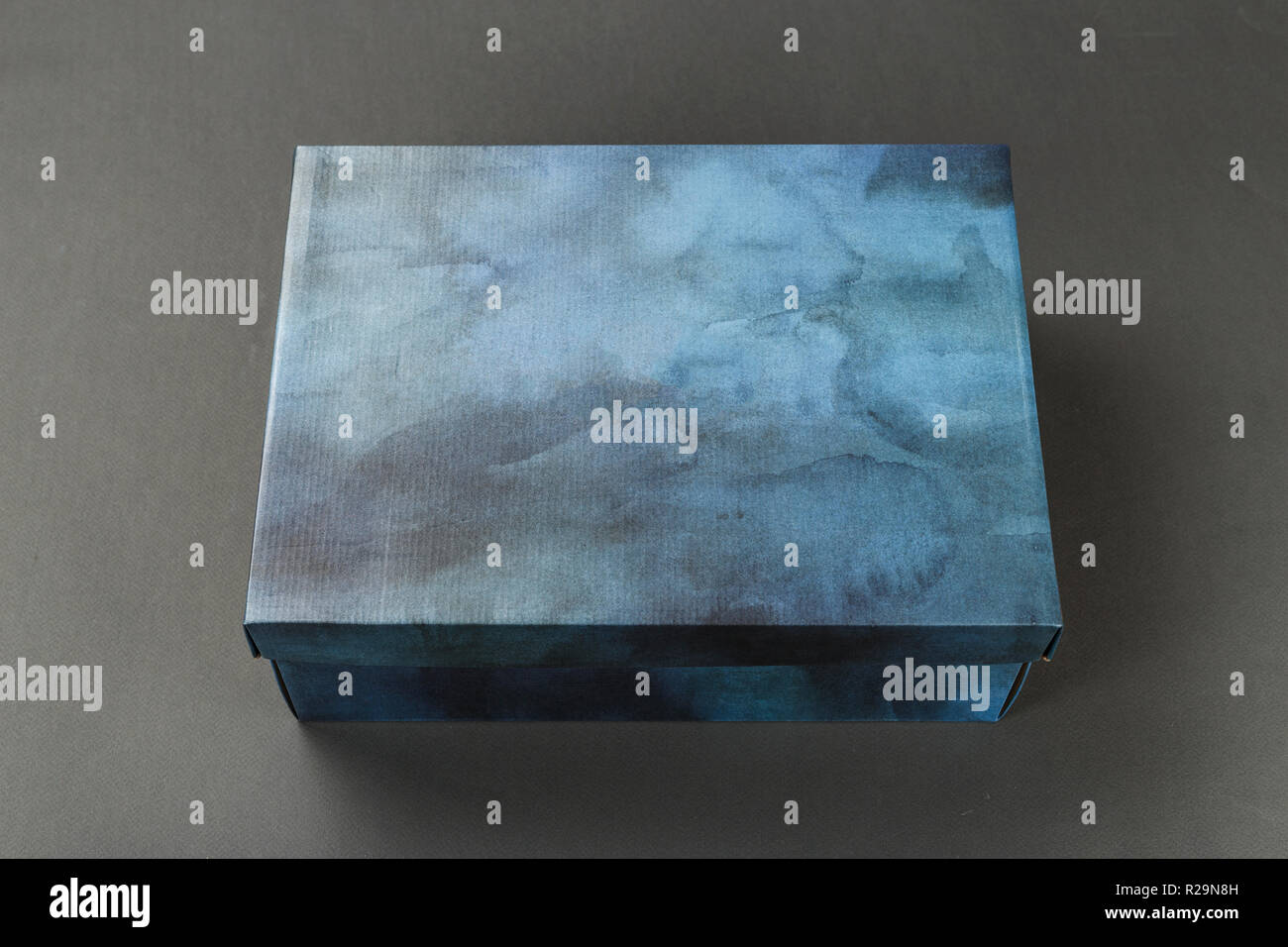 blue shoe box with lid closed on black background. space for text Stock ...