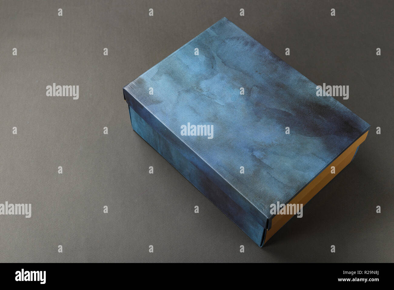 blue shoe box with lid closed on black background. space for text Stock ...