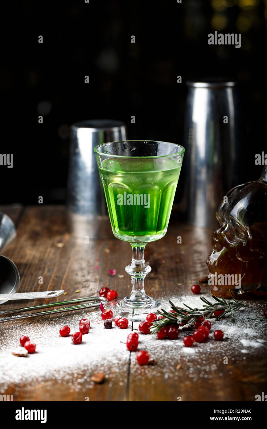 cocktail with absinthe for Halloween in a glass in the form of a skull ...