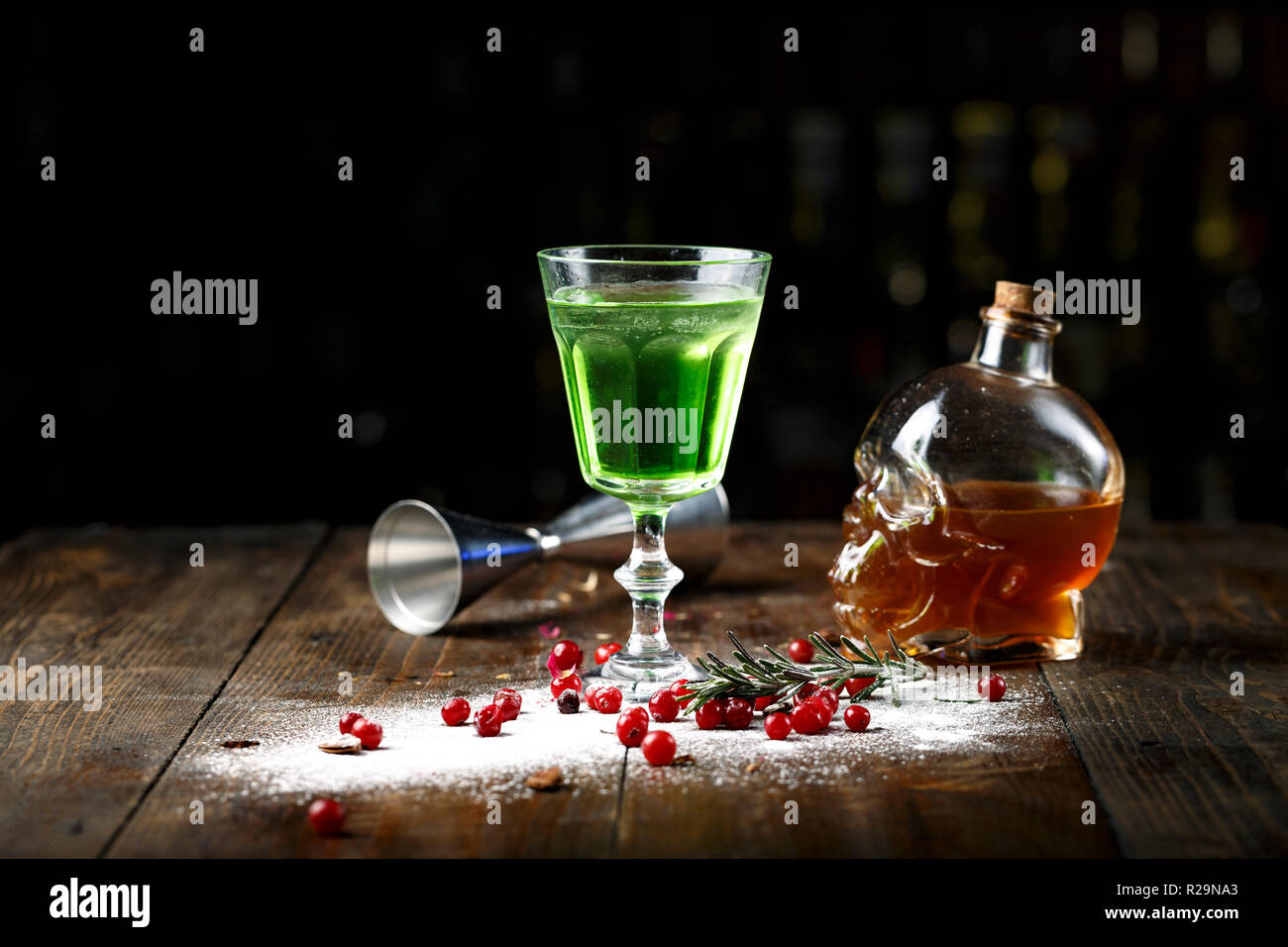 cocktail with absinthe for Halloween in a glass in the form of a skull ...