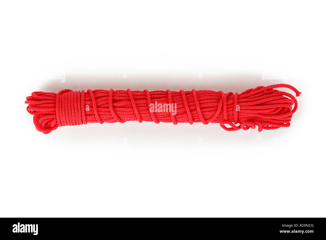 reeled up red nylon rope isolated on white background Stock Photo - Alamy