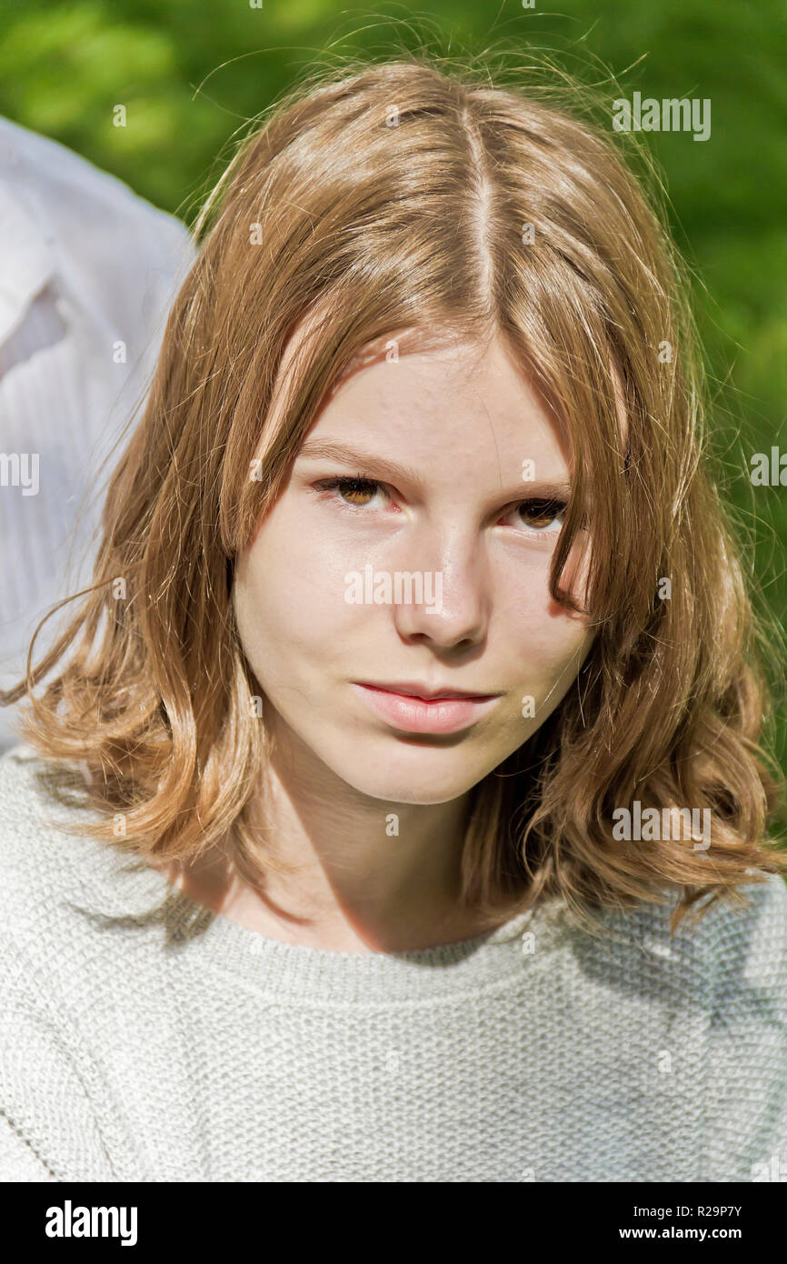 Cute blond girl fourteen years old in summer background Stock Photo - Alamy