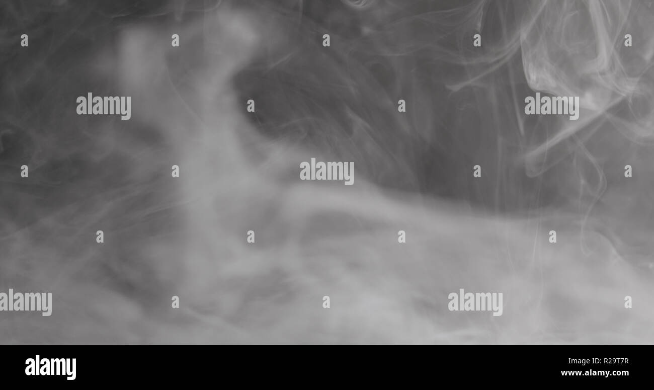 Slow motion closeup vapor floating in air on black background, wide ...
