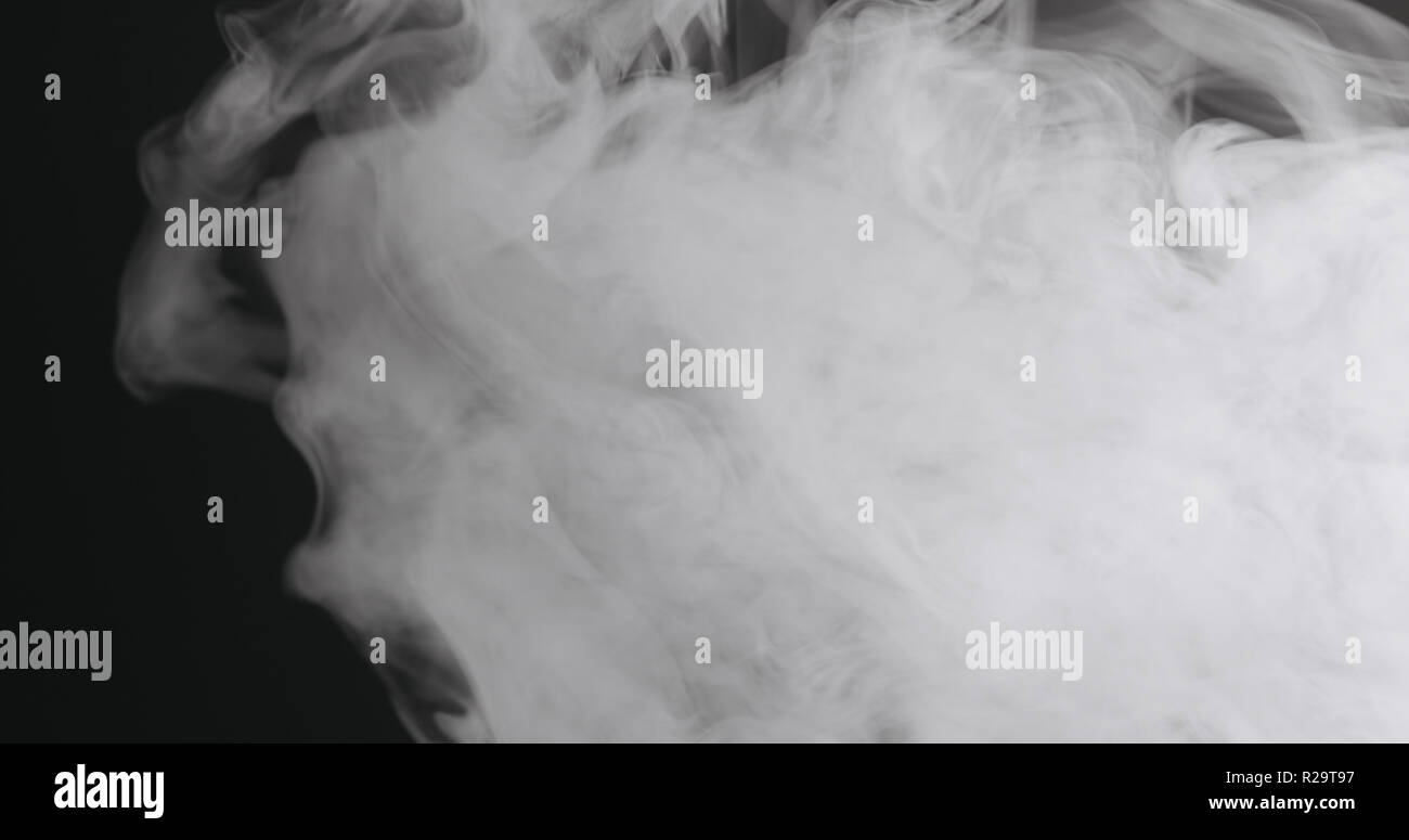 Slow motion closeup vapor floating in air on black background, wide ...