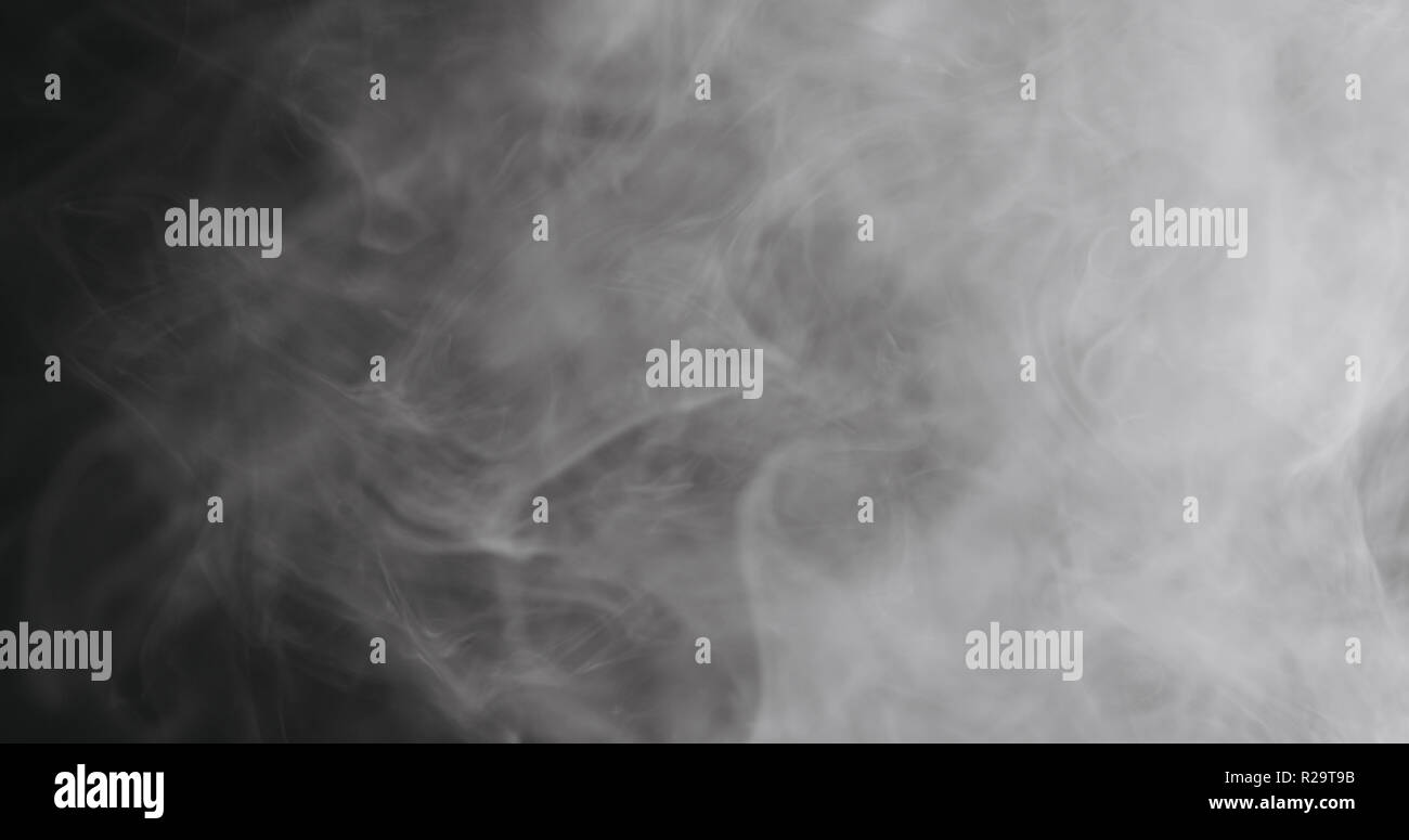 Slow motion closeup vapor floating in air on black background, wide ...
