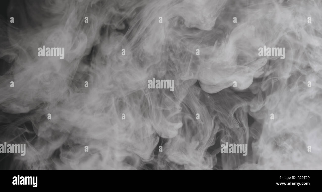 Slow motion closeup vapor floating in air on black background, wide ...