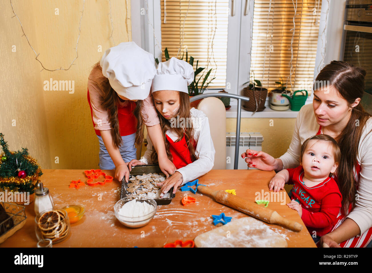 Family with children preparing cookies for Xmas in kitchen Stock Photo ...