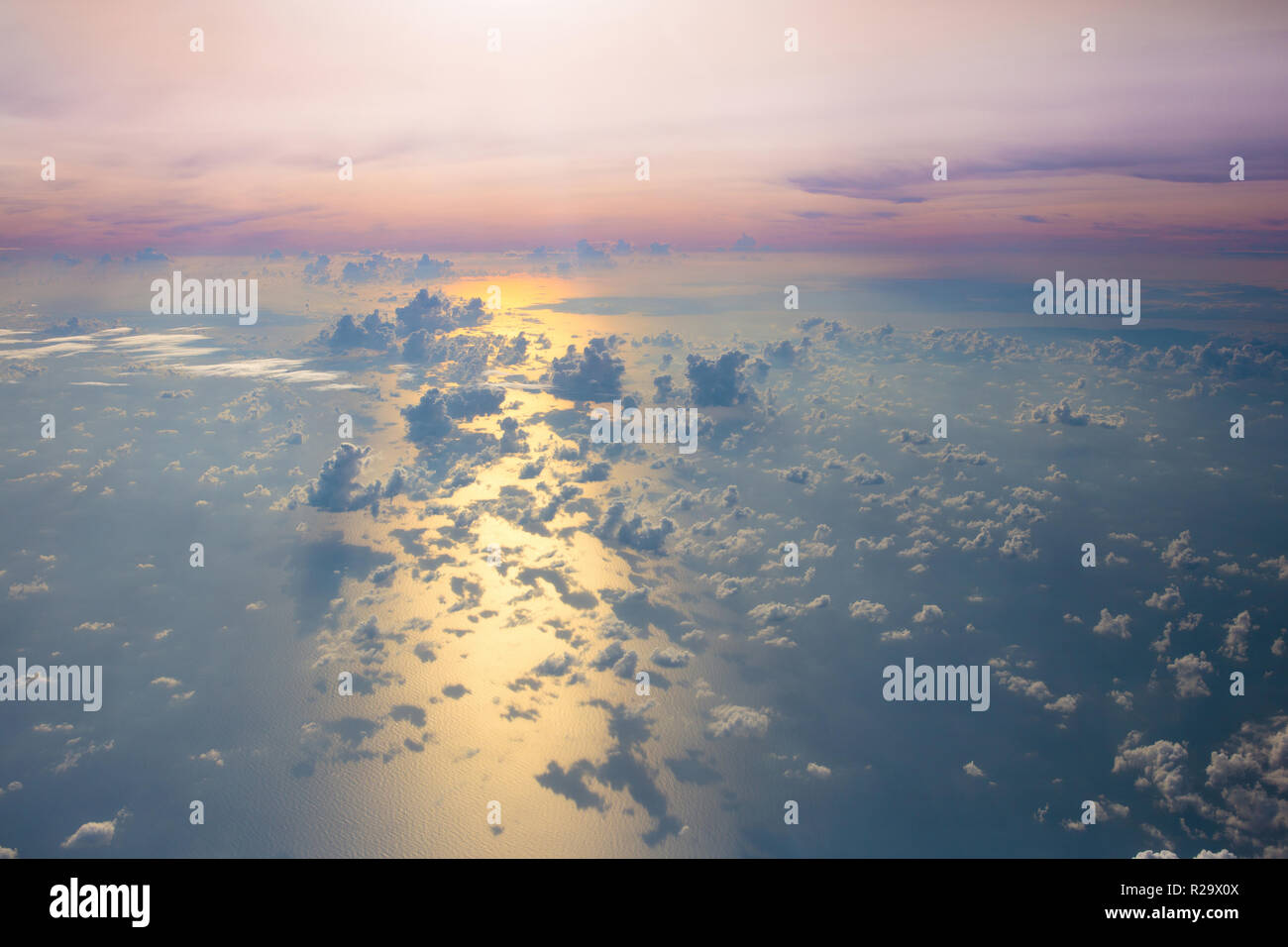 Ocean at sunset or sunrise, view from airplane window. Sea waves and ...