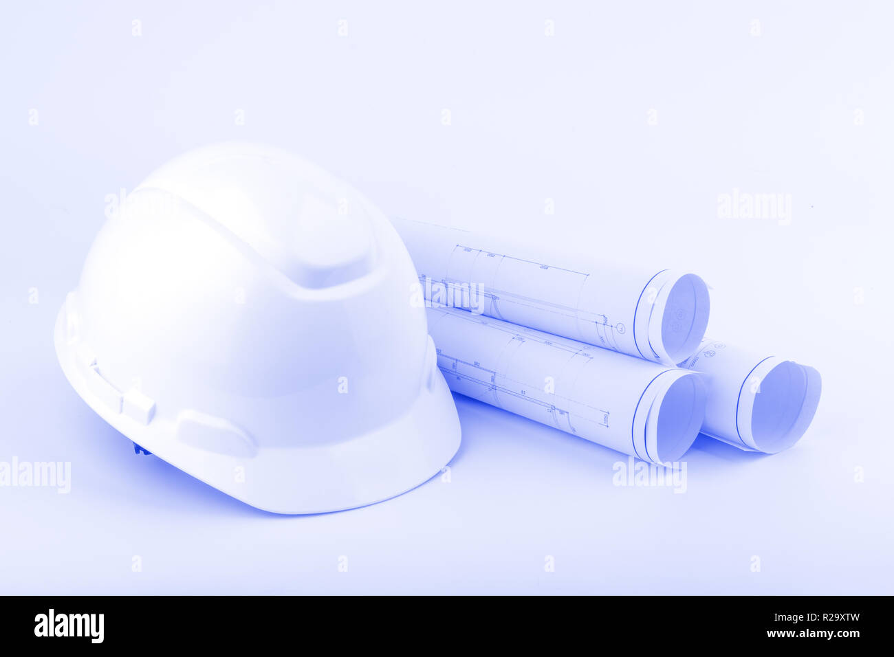 White safety helmet and Scrolls of engineering drawings Stock Photo - Alamy