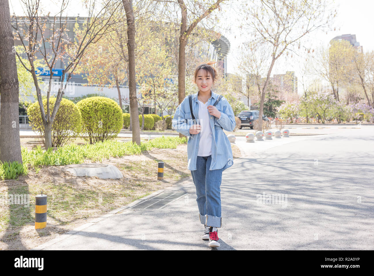 Female student walking in campus Stock Photo - Alamy