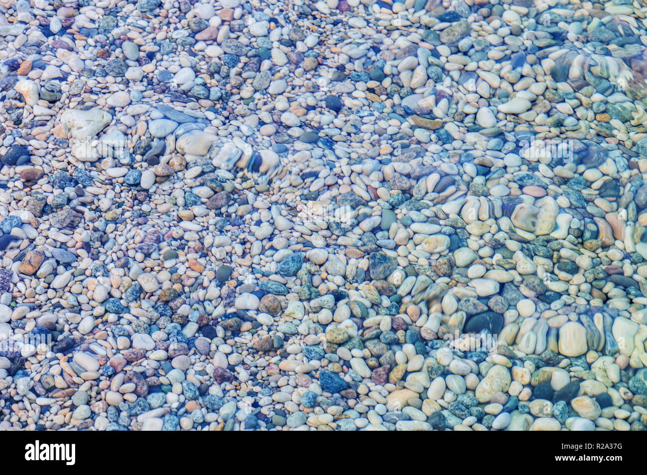multicolored pebbles under water on the beach background Stock Photo ...