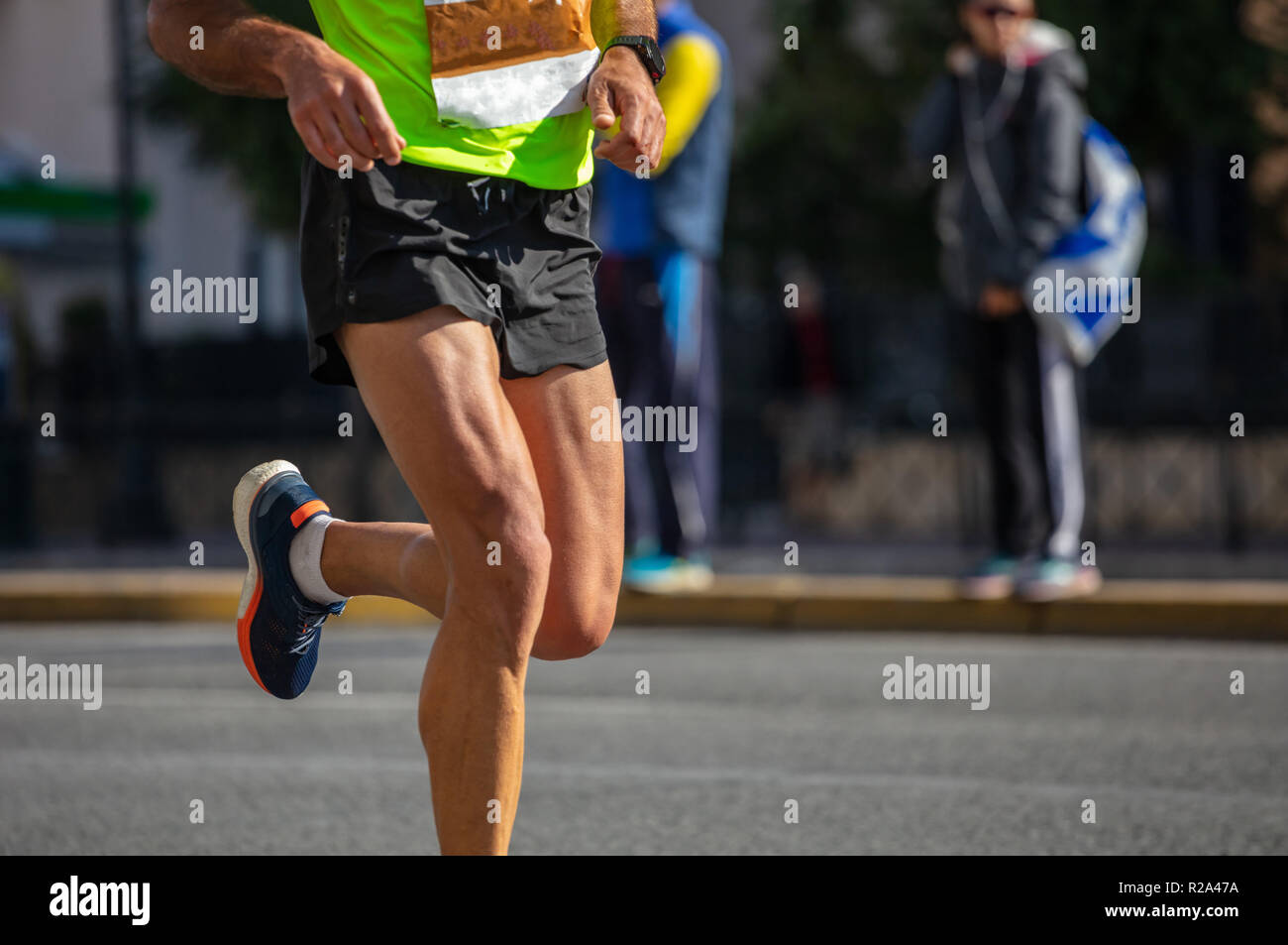 Running in the city roads. Young man runner, front view, blur ...